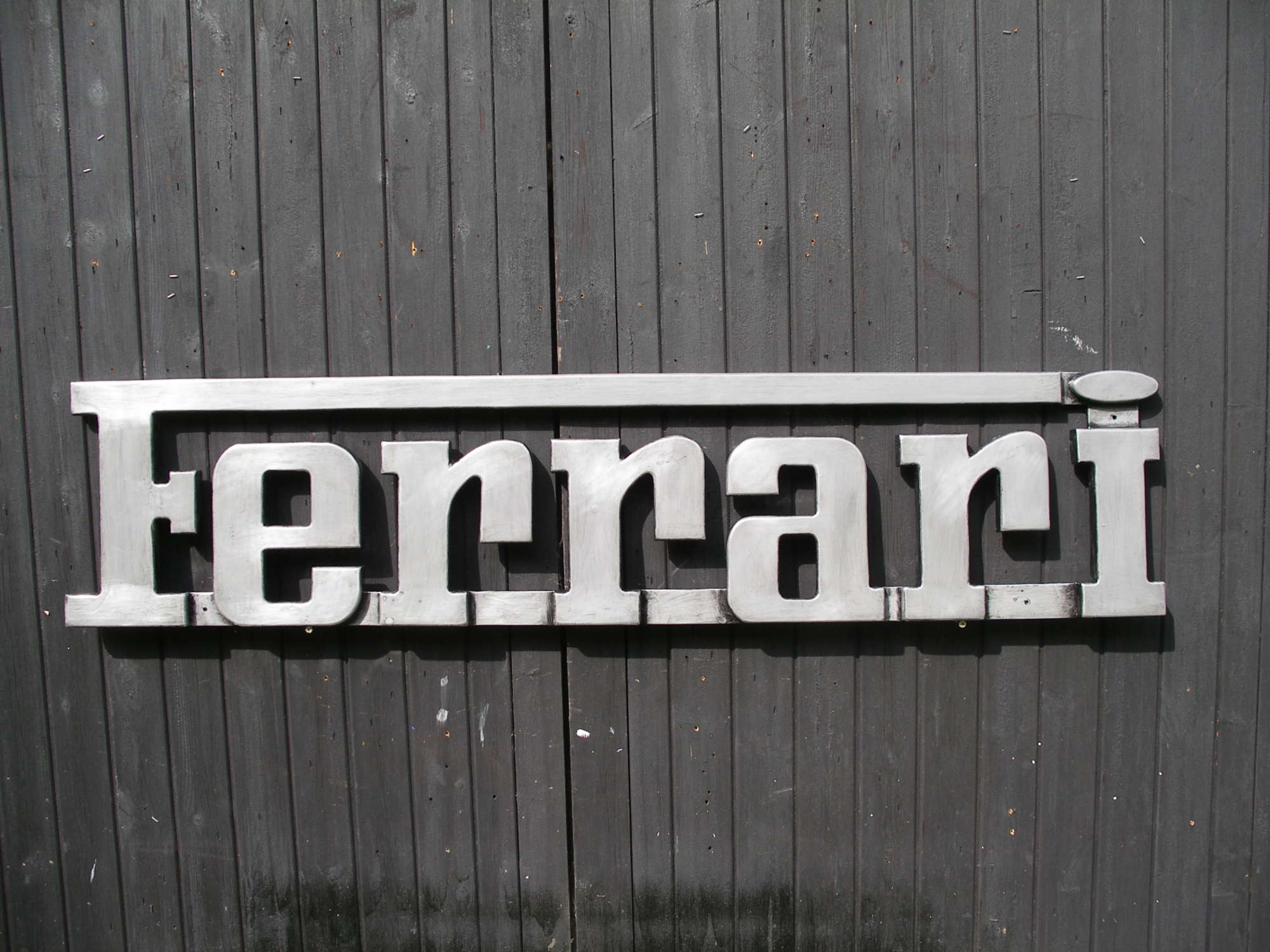 Iconic Auctioneers | Cold cast aluminium 'Ferrari' script-Sold